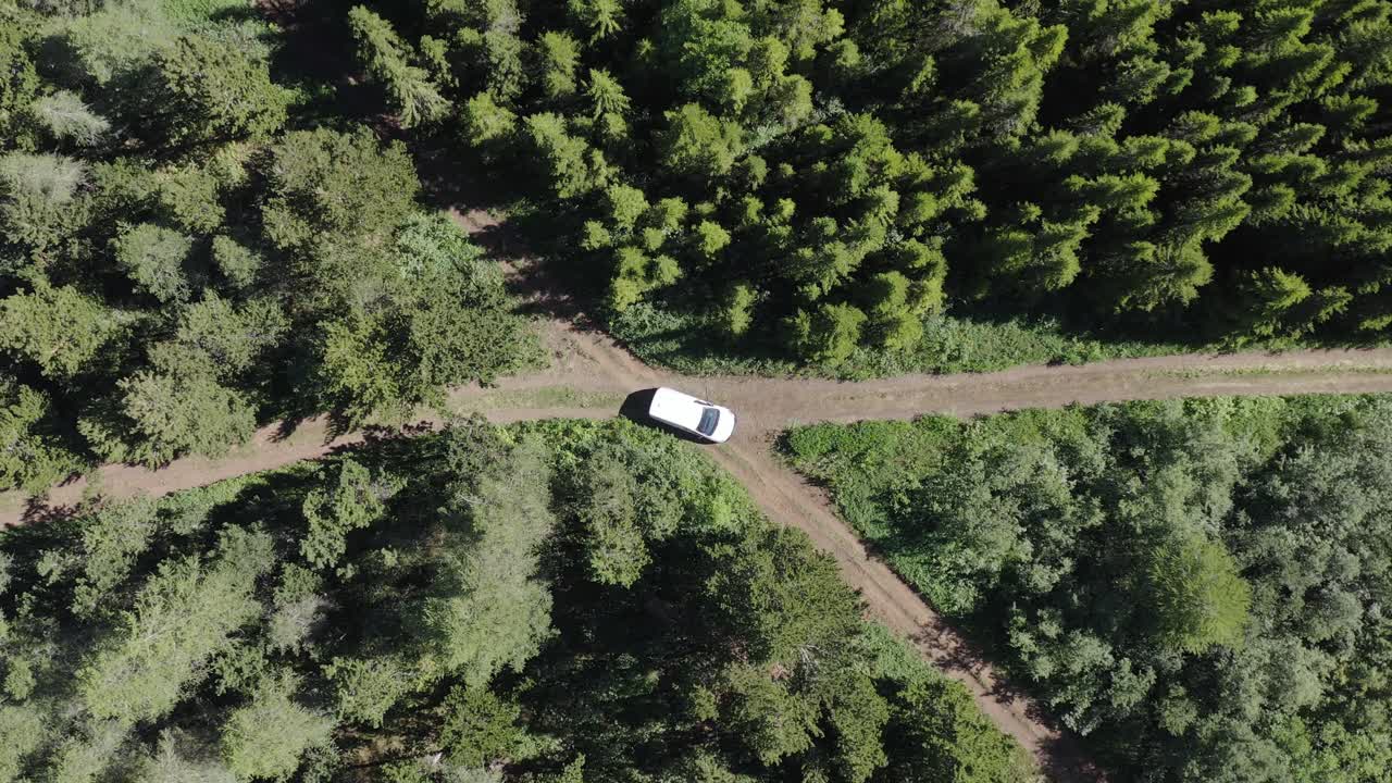 White Car Parked On Dirt Road Intersection In Middle Of Green Forest ...