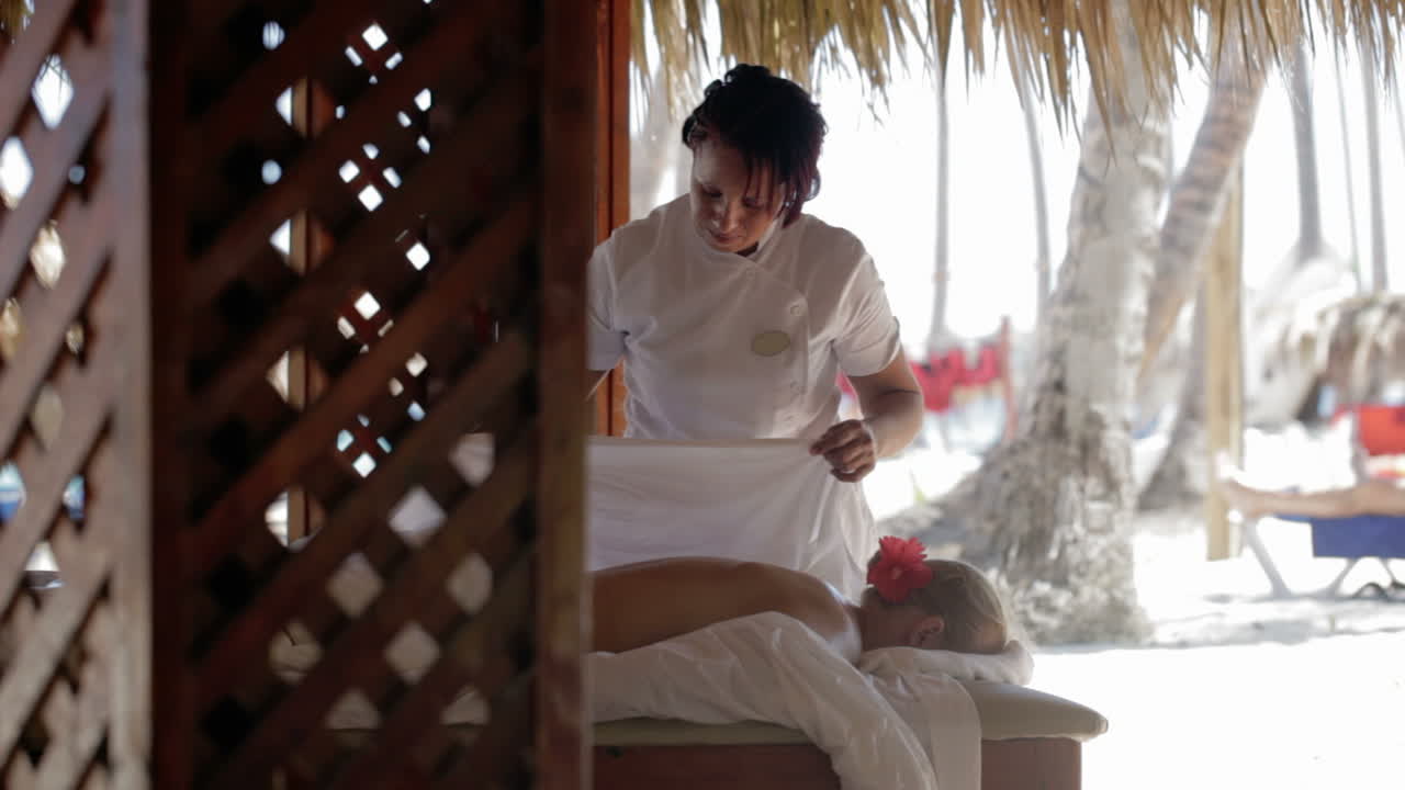 Premium stock video - Massage therapist finishing spa treatment