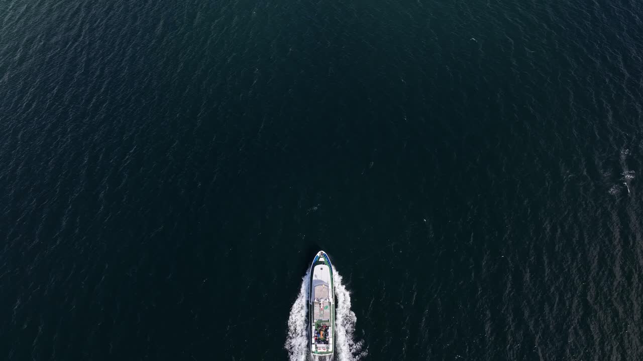 Premium stock video - Drone overtaking charter tourist boat in birdseye ...