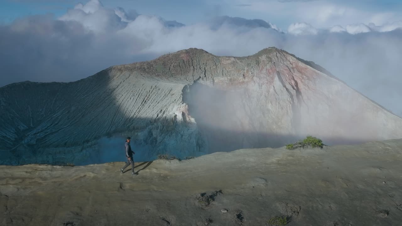 Man Adventure Hiking Along Cliff Ridge At Active Volcano In East Java ...