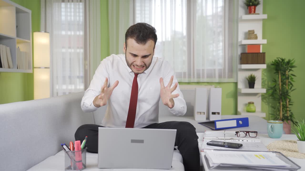 Premium stock video - Serious and focused working man gets angry at ...