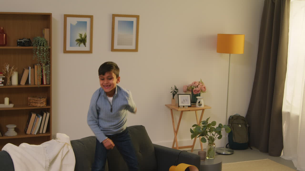 Free stock video - Disruptive young boy behaving badly at home jumping ...