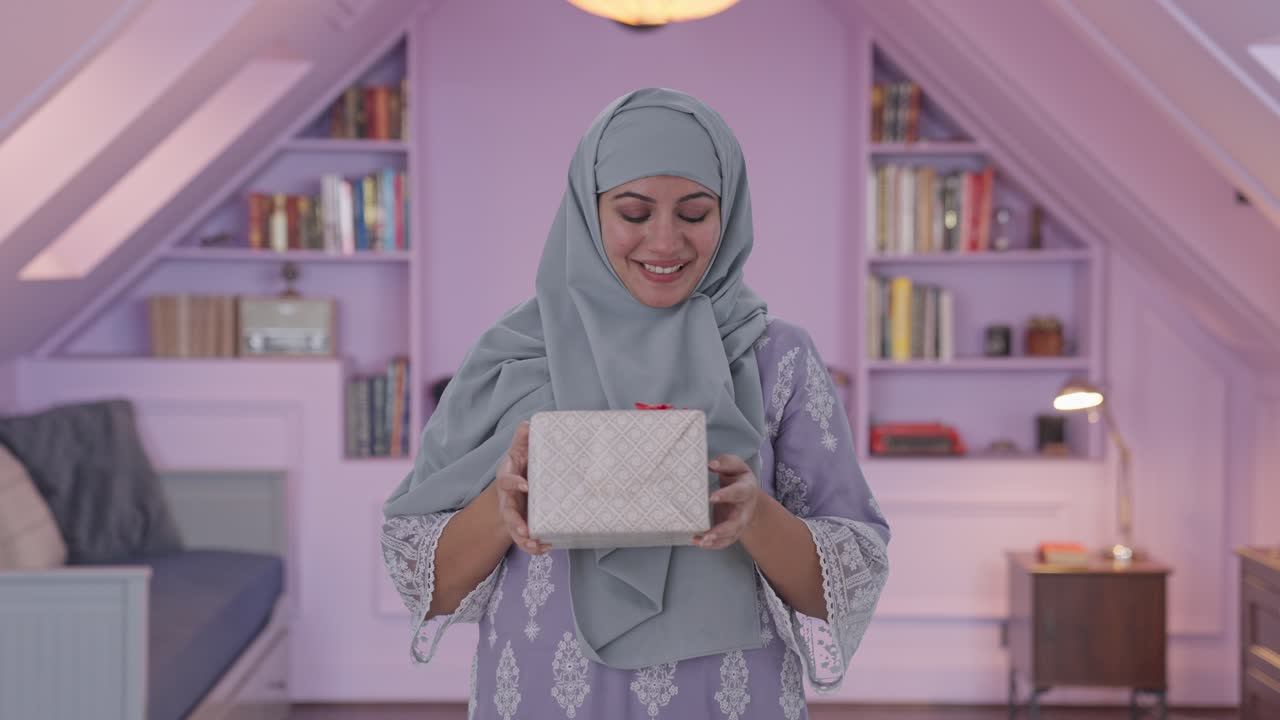 Premium stock video - Happy muslim woman receiving a gift