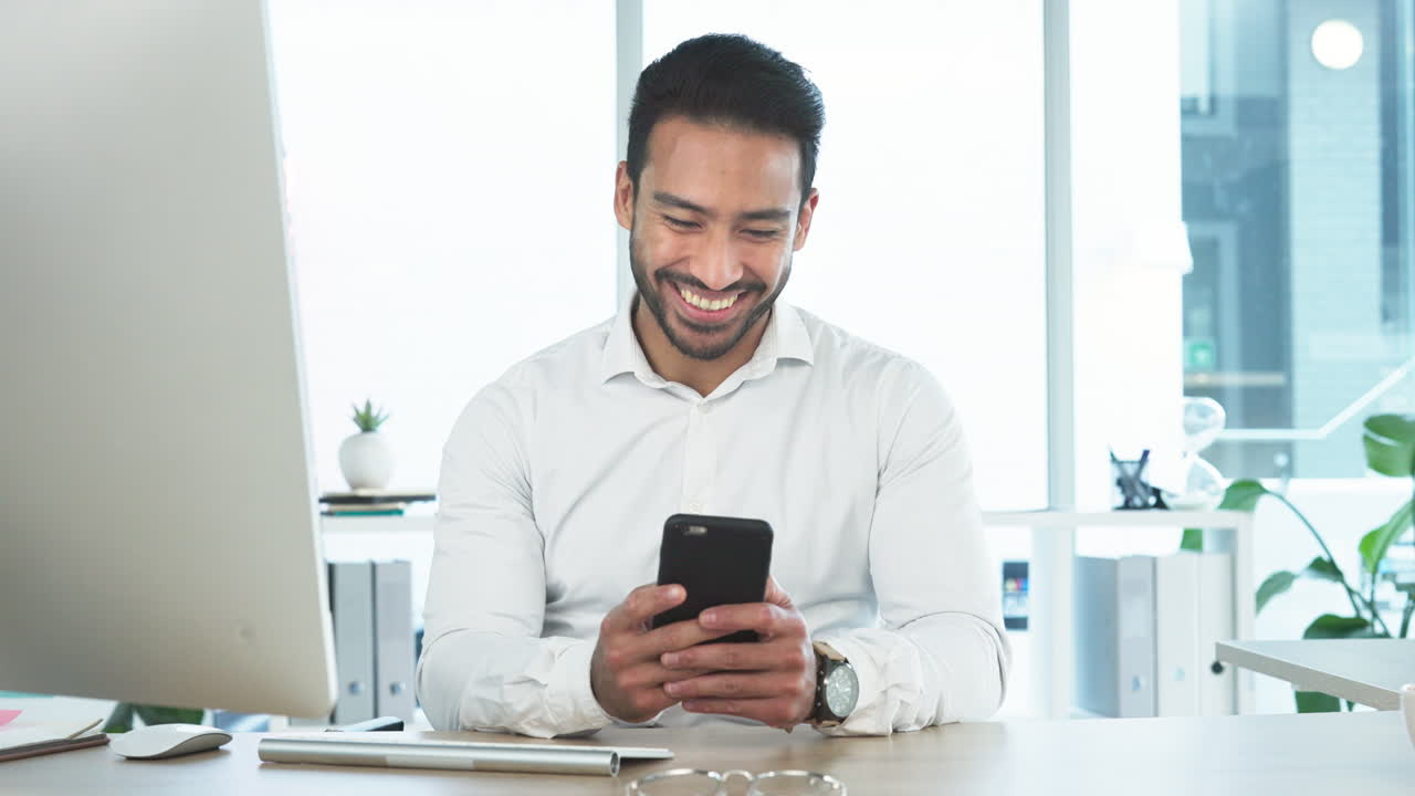 Premium stock video - Man laughing while typing and sending texts to