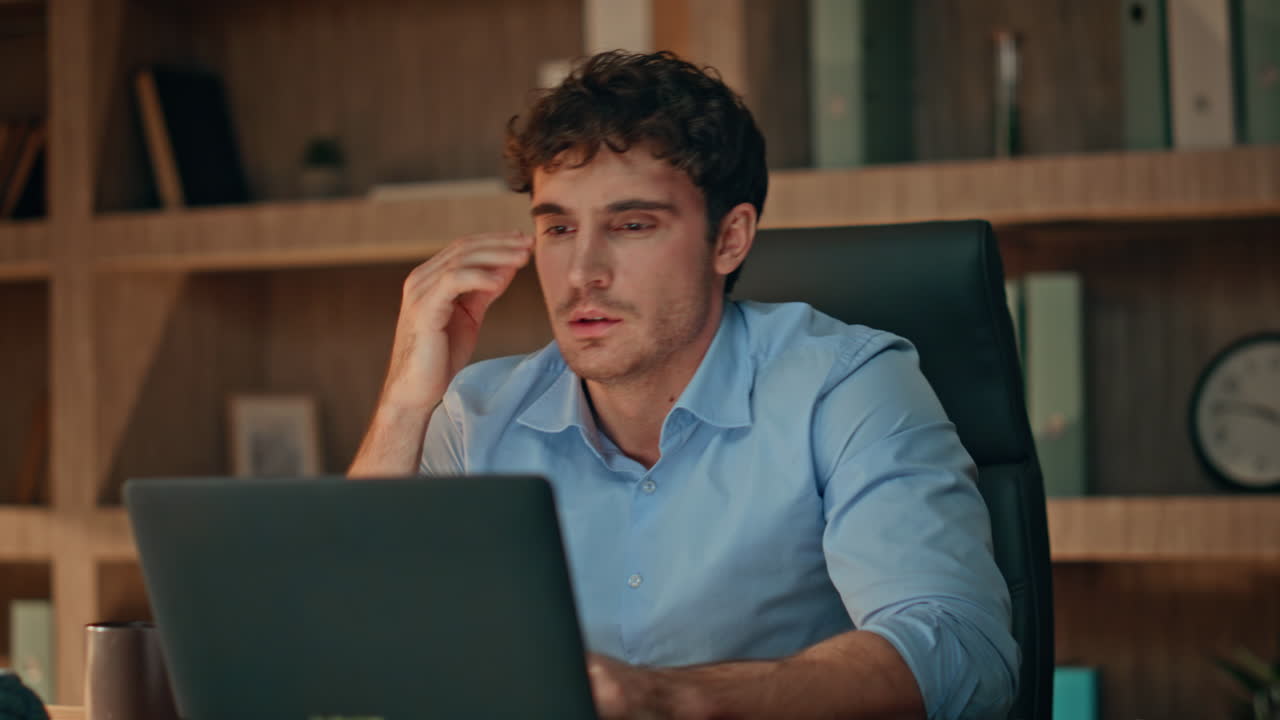Fatigued employee watching computer screen having overtime work office ...