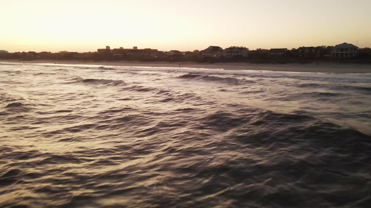 Premium stock video - Drone pulling back revealing beach with fast ...