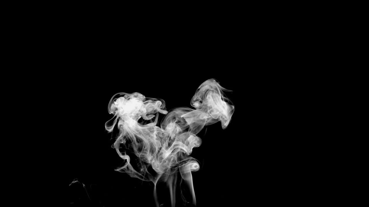 Premium stock video - Rising puff of white smoke on black background