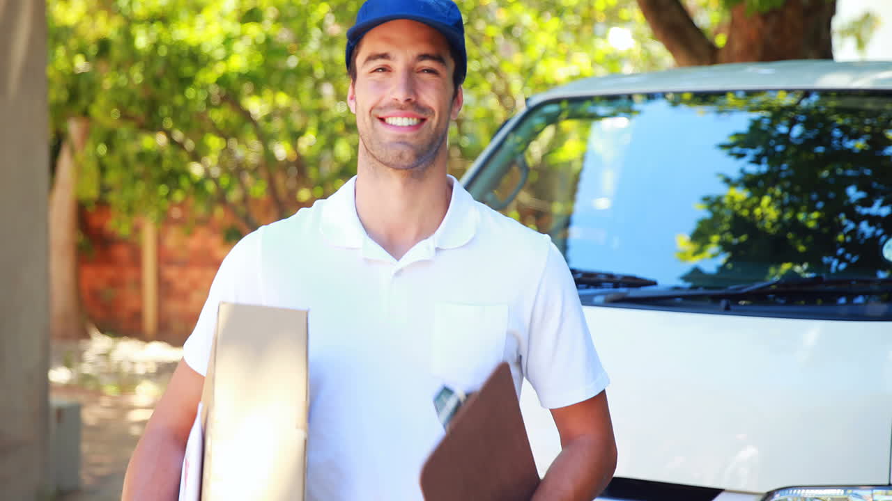 Premium stock video - Delivery man carrying a parcel