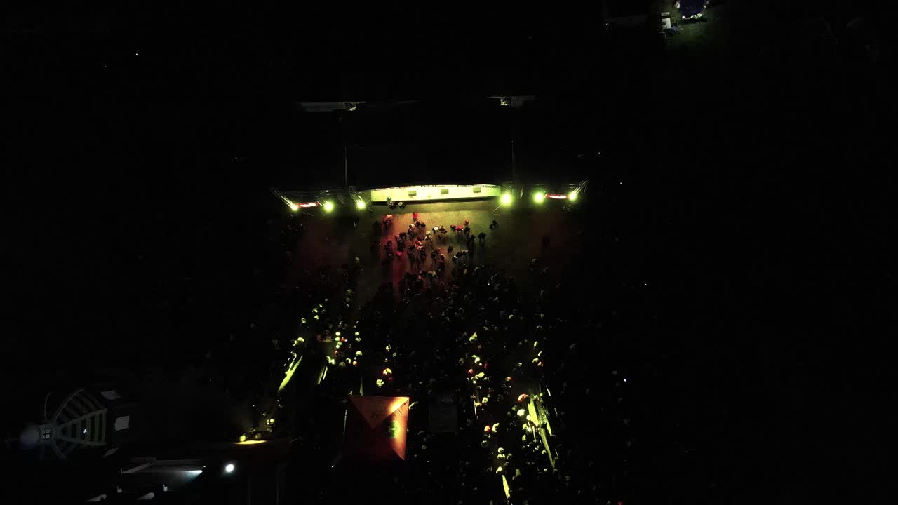 Premium stock video - Aerial view of concert crowd in front of stage in ...