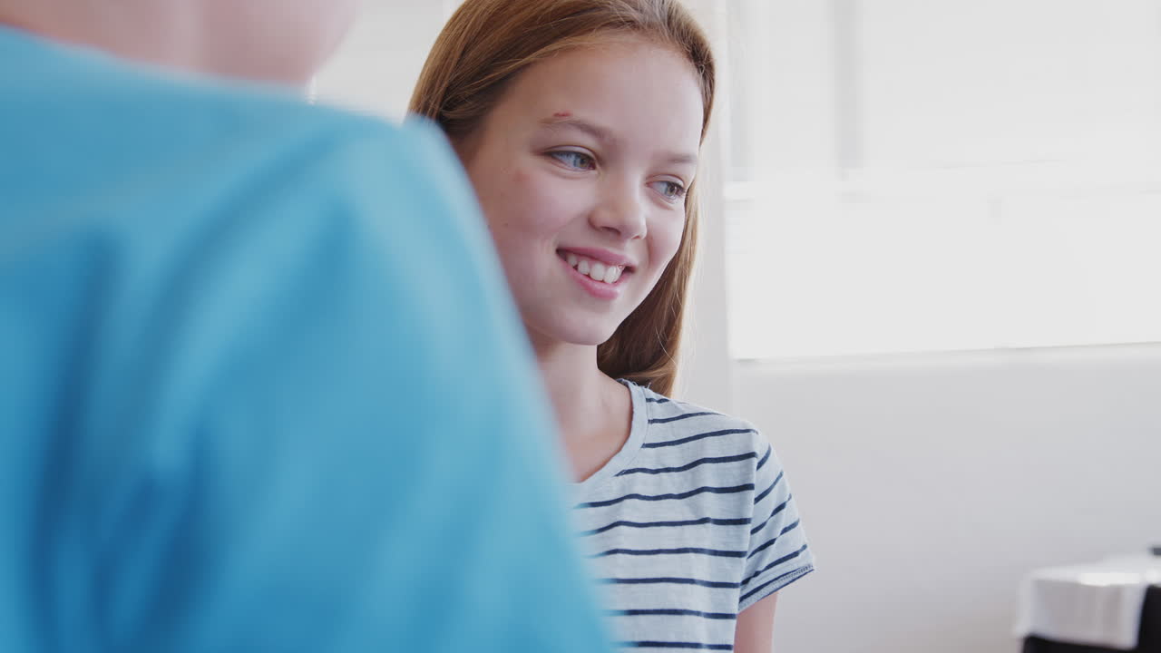 Premium stock video - Male and female students in class working together