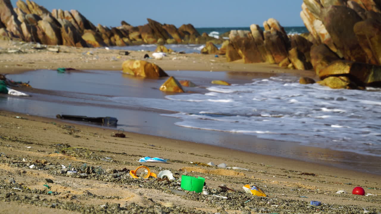 Premium stock video - Beach polluted with plastic ocean trash, tide ...