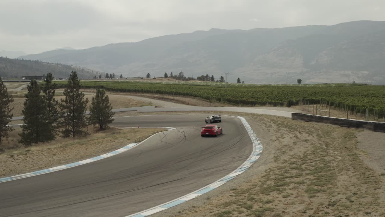 Premium stock video - Back view of exotic cars driving on osoyoos race ...