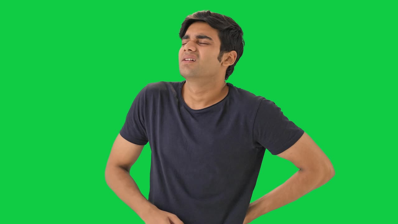 Premium stock video - Indian man suffering from back pain green screen