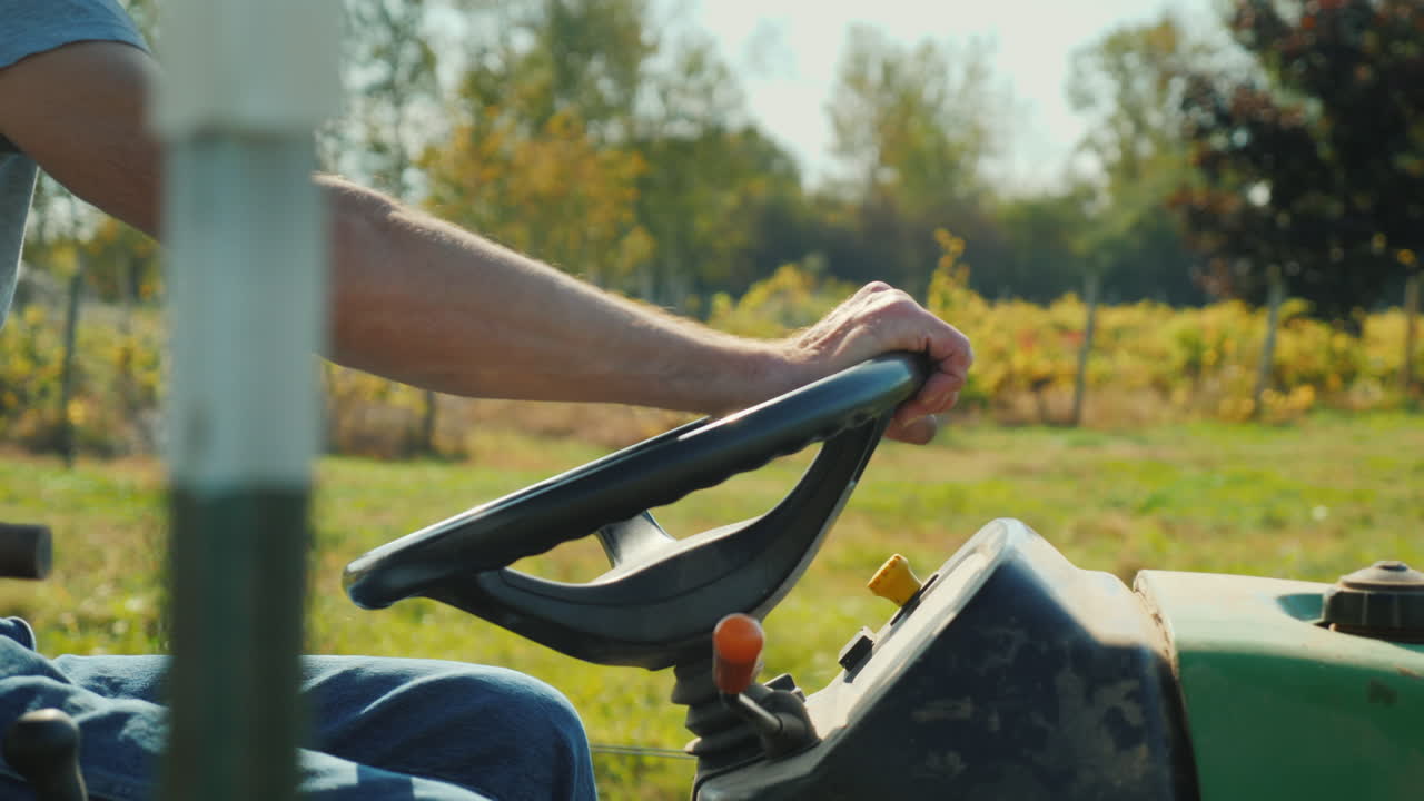 Premium stock video - Farmer driving small tractor