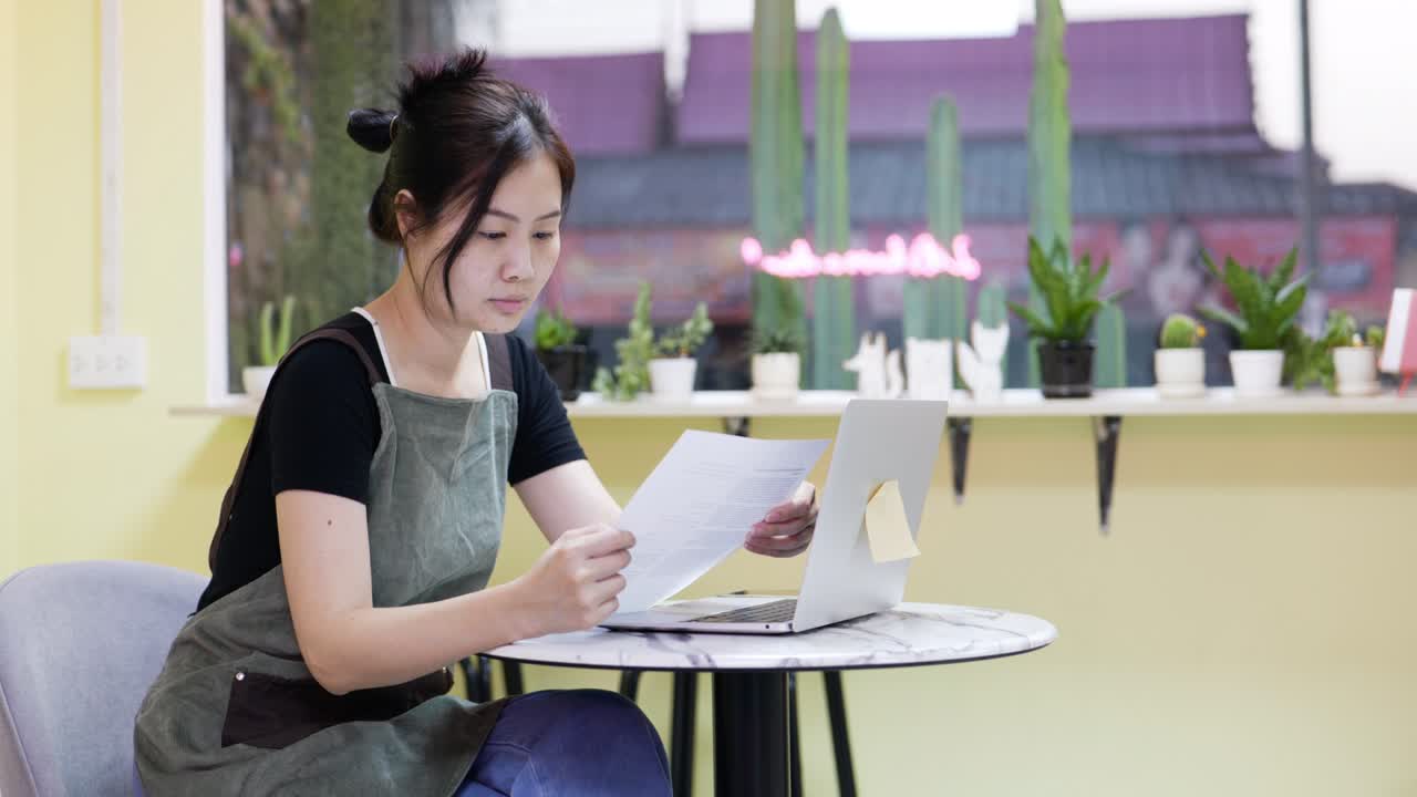 Restaurant manager looking over documents. | Premium Stock Video Footage