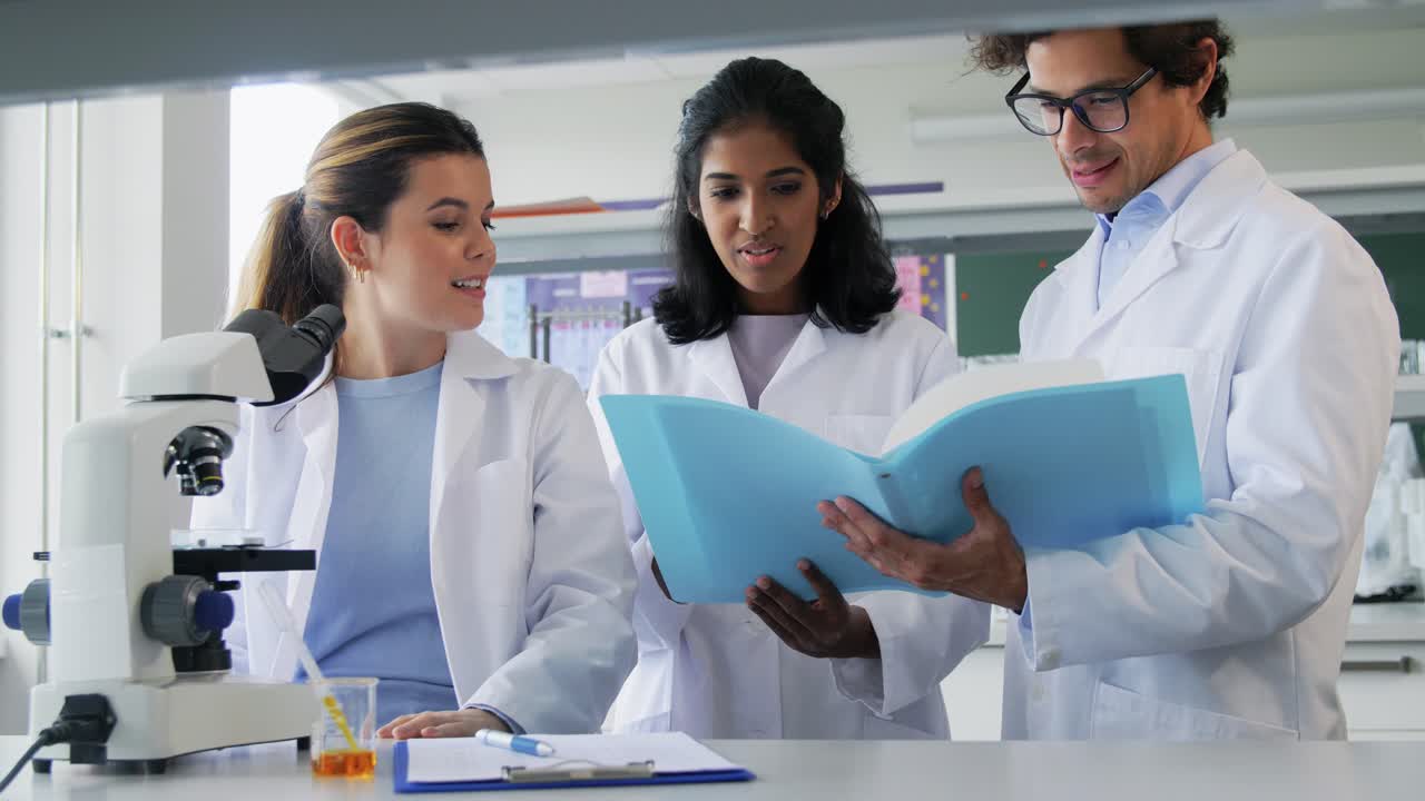 Premium stock video - Scientists with microscopes working in laboratory ...