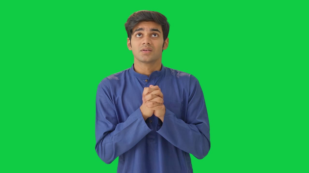 Premium stock video - Scared indian man praying to god green screen
