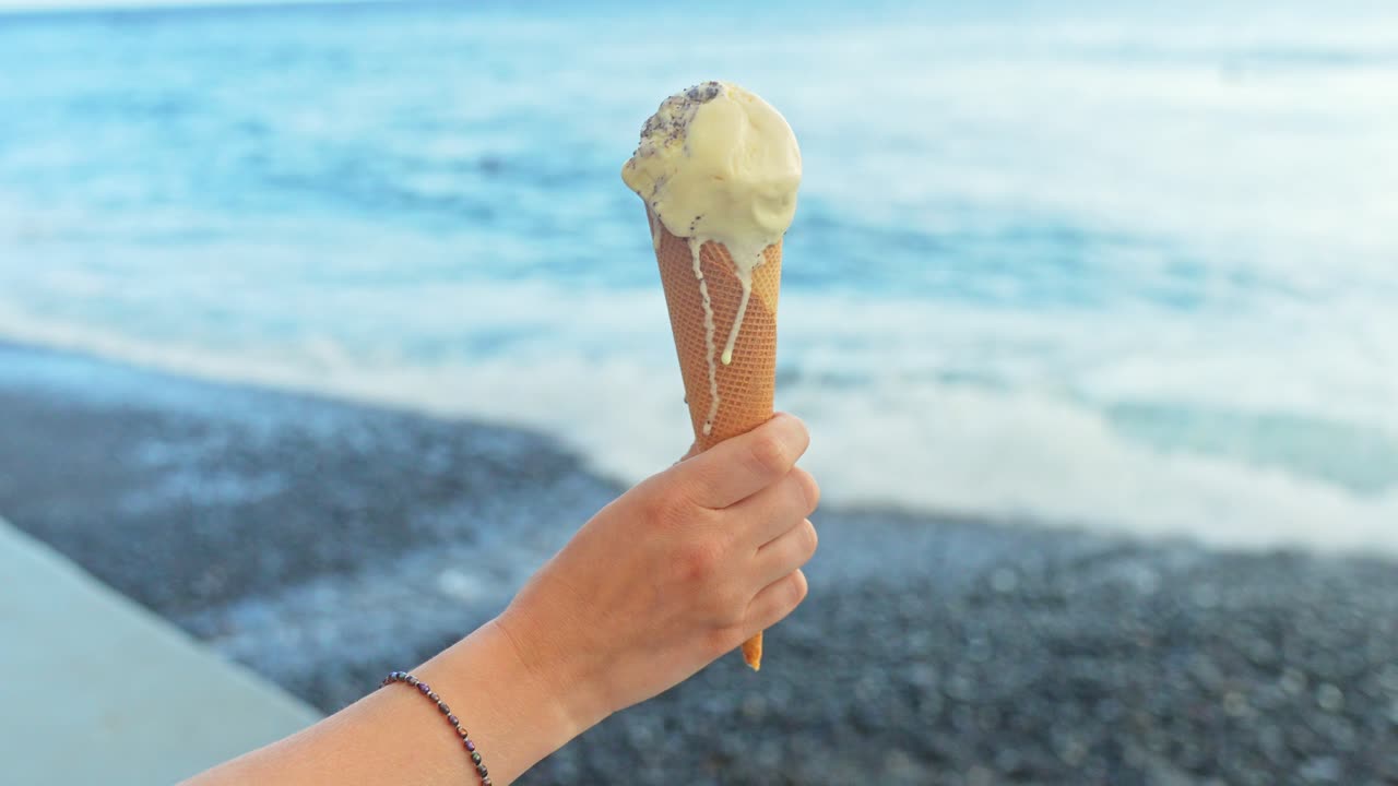 Premium stock video - Melting ice cream treat feasting at beach las ...