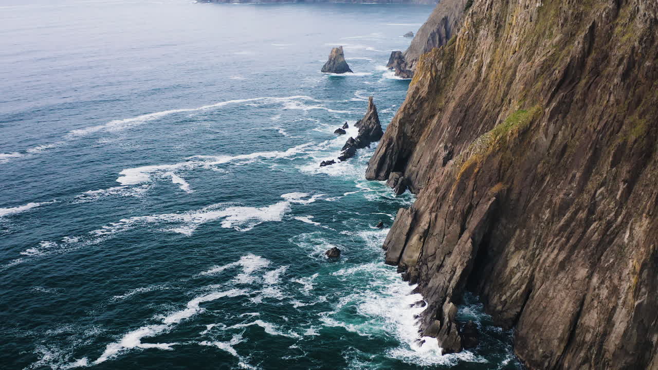 Steep, rocky coastline of oregon coast on pacific ocean, slow aerial ...