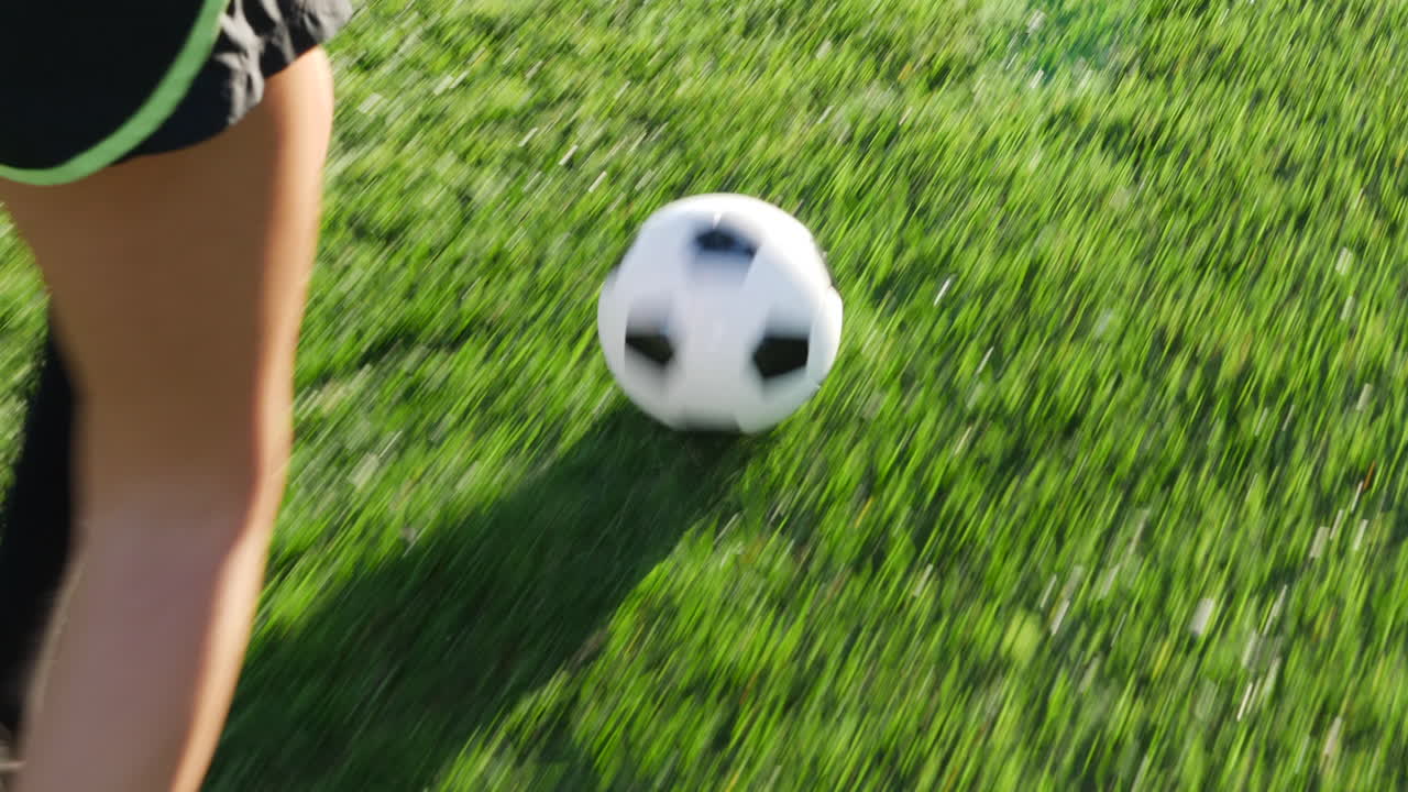 Premium stock video - A soccer player running with a football dribbling ...