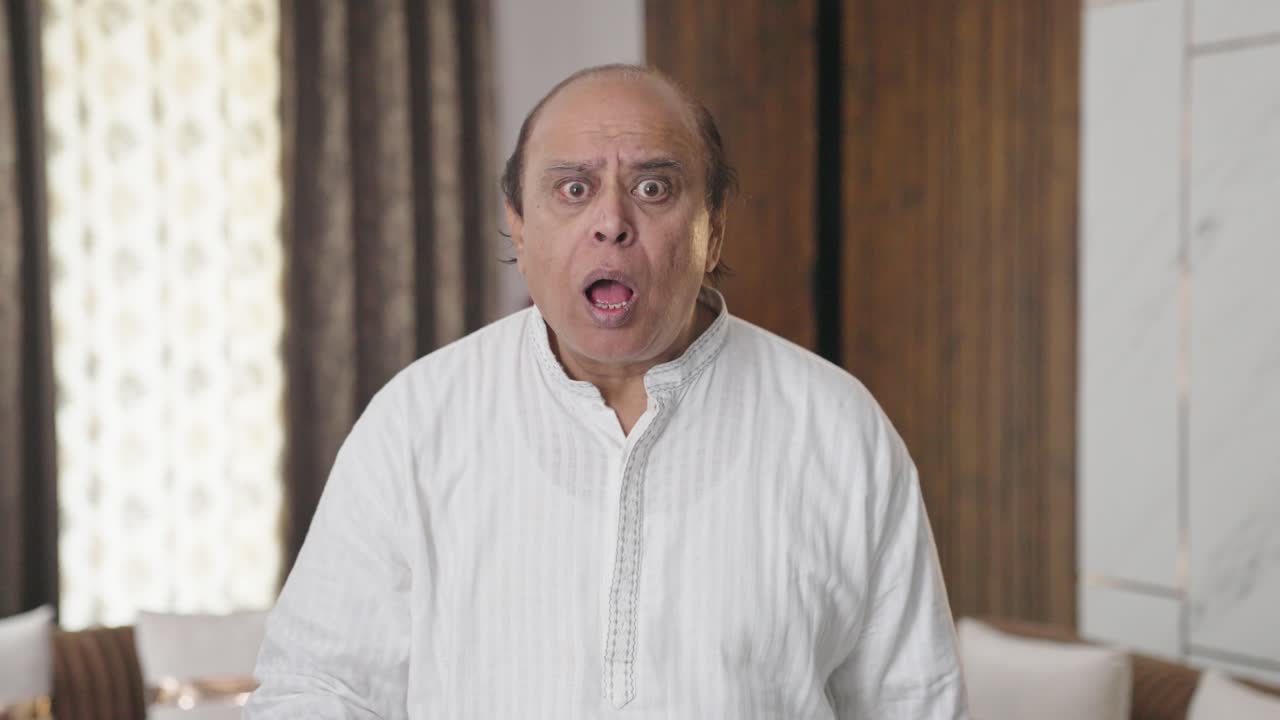 Premium stock video - Indian old man getting shocked