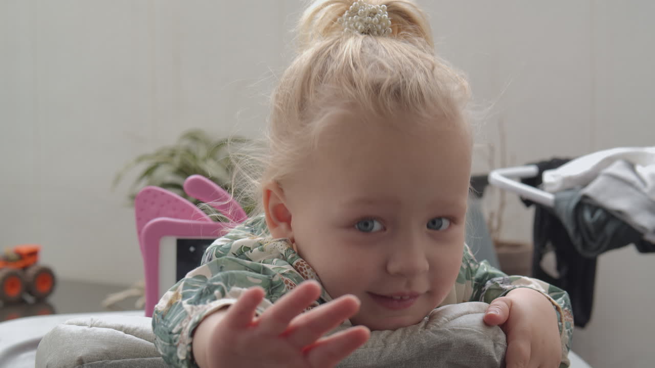 Cute girl toddler waving hand to the camera Premium Stock Video Footage