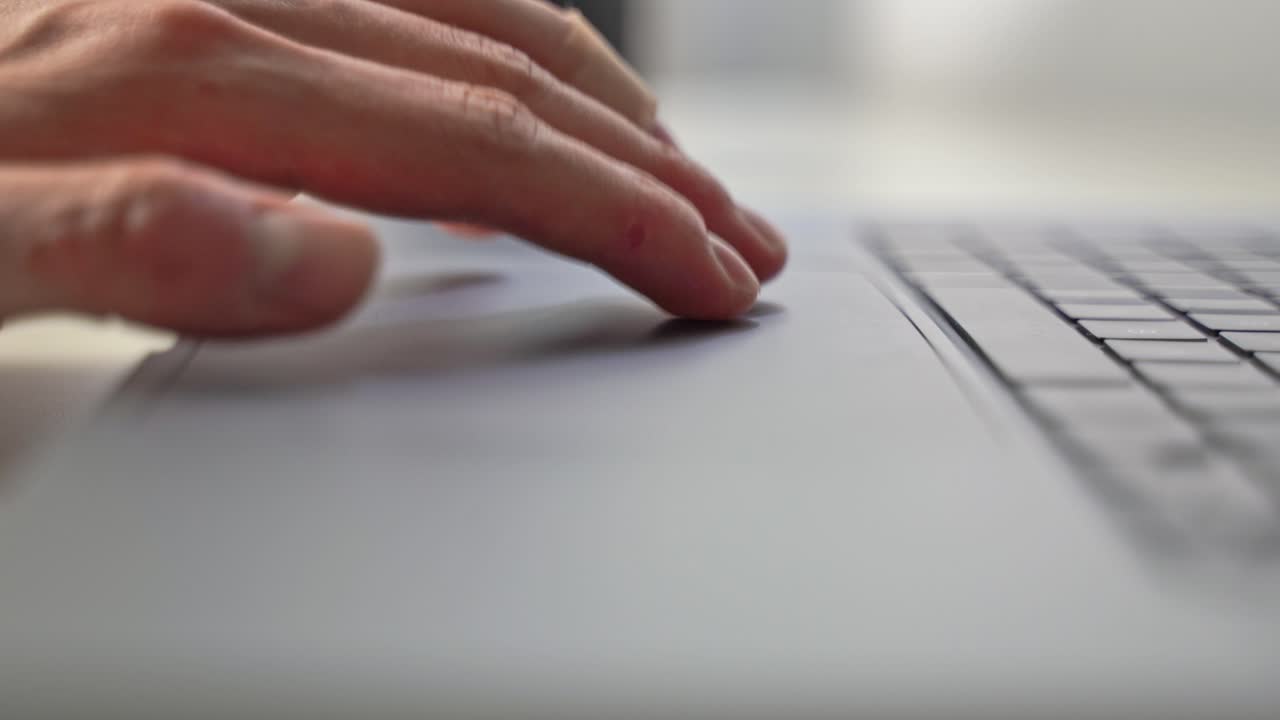Premium stock video - Hands patiently use the computer laptop touchpad ...