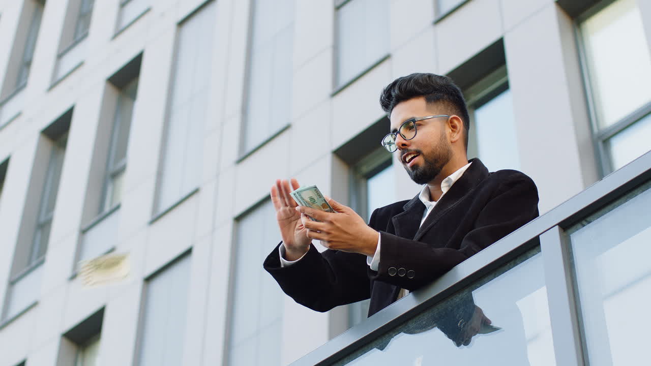 Premium stock video - Happy rich businessman wasting throwing money ...