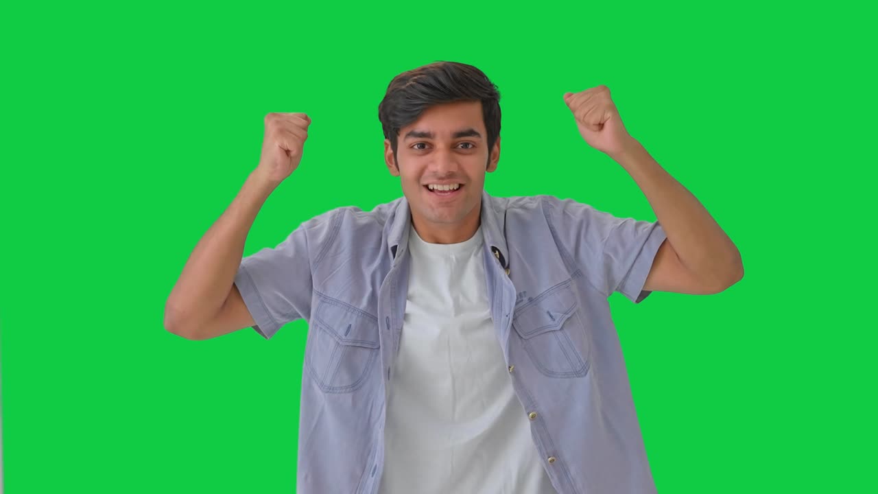 Premium stock video - Indian boy cheering and celebrating green screen