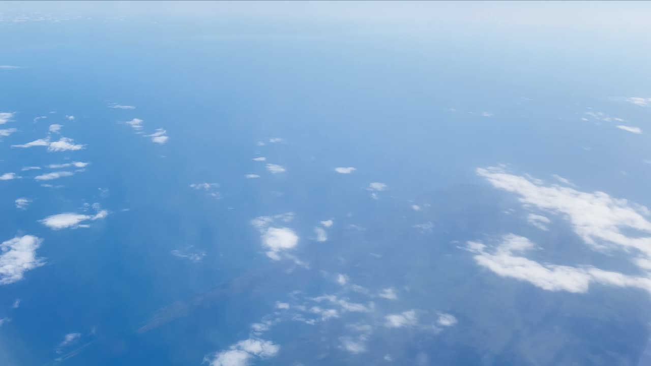 Premium stock video - View 30,000 feet above the earth in a plane