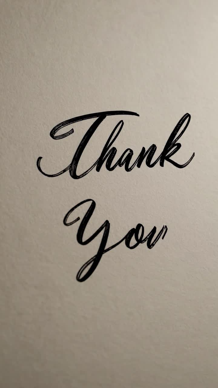 Elegant thank you message in cursive on textured paper, captured from a ...