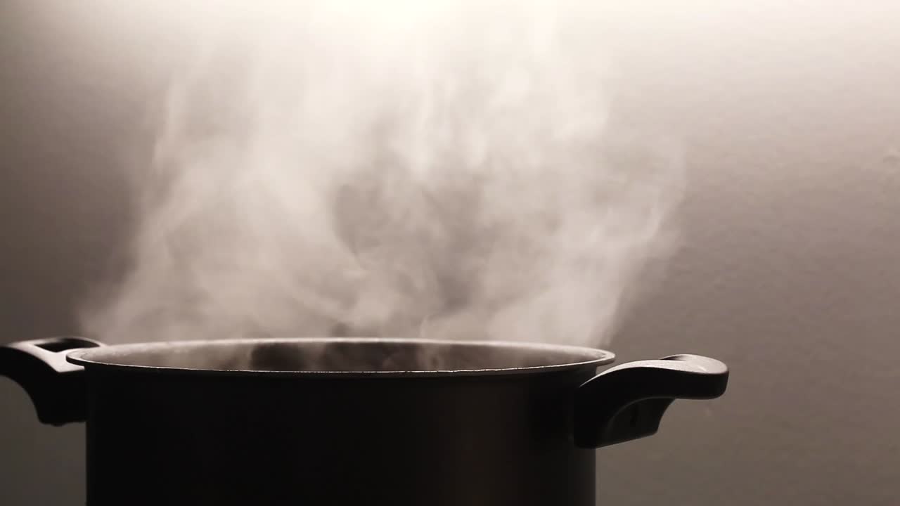 Premium stock video - Steam is coming out of a cooking pot