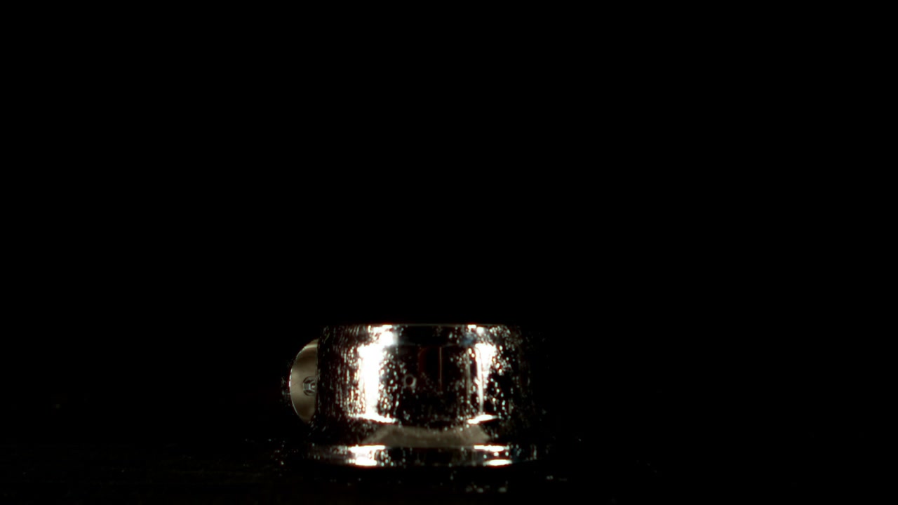 Premium stock video - Alarm clock falling on black background