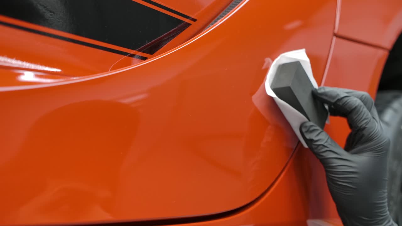 Application of ceramic coating on the red car using suede cloth on the ...
