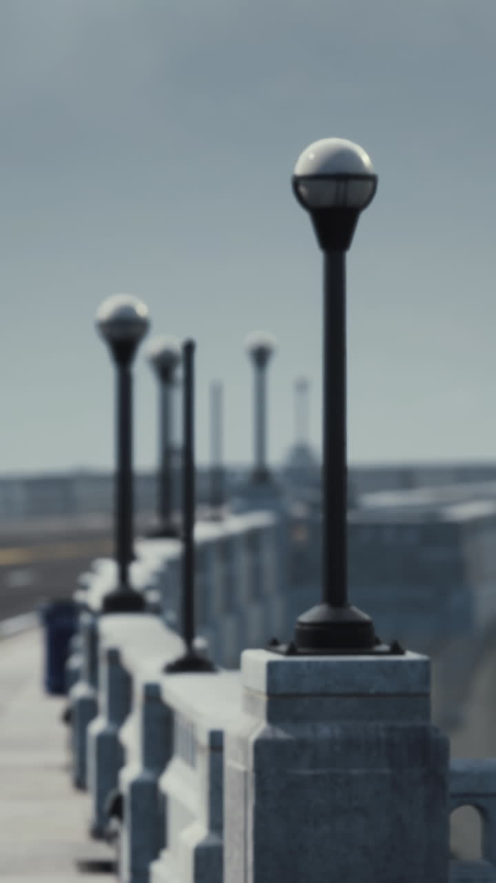 Premium stock video - A row of lamp posts on a bridge