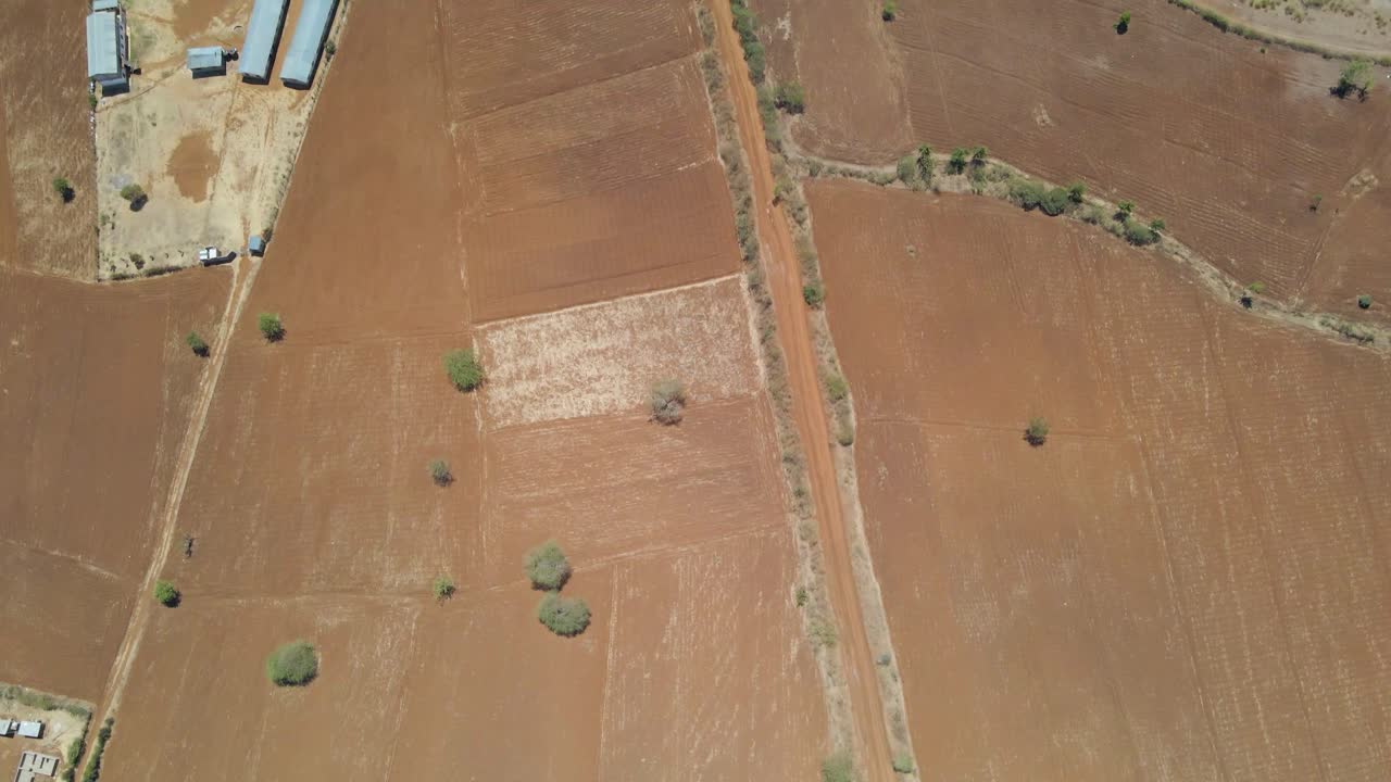 Premium stock video - High angle tilt up over dry meadows, revealing ...
