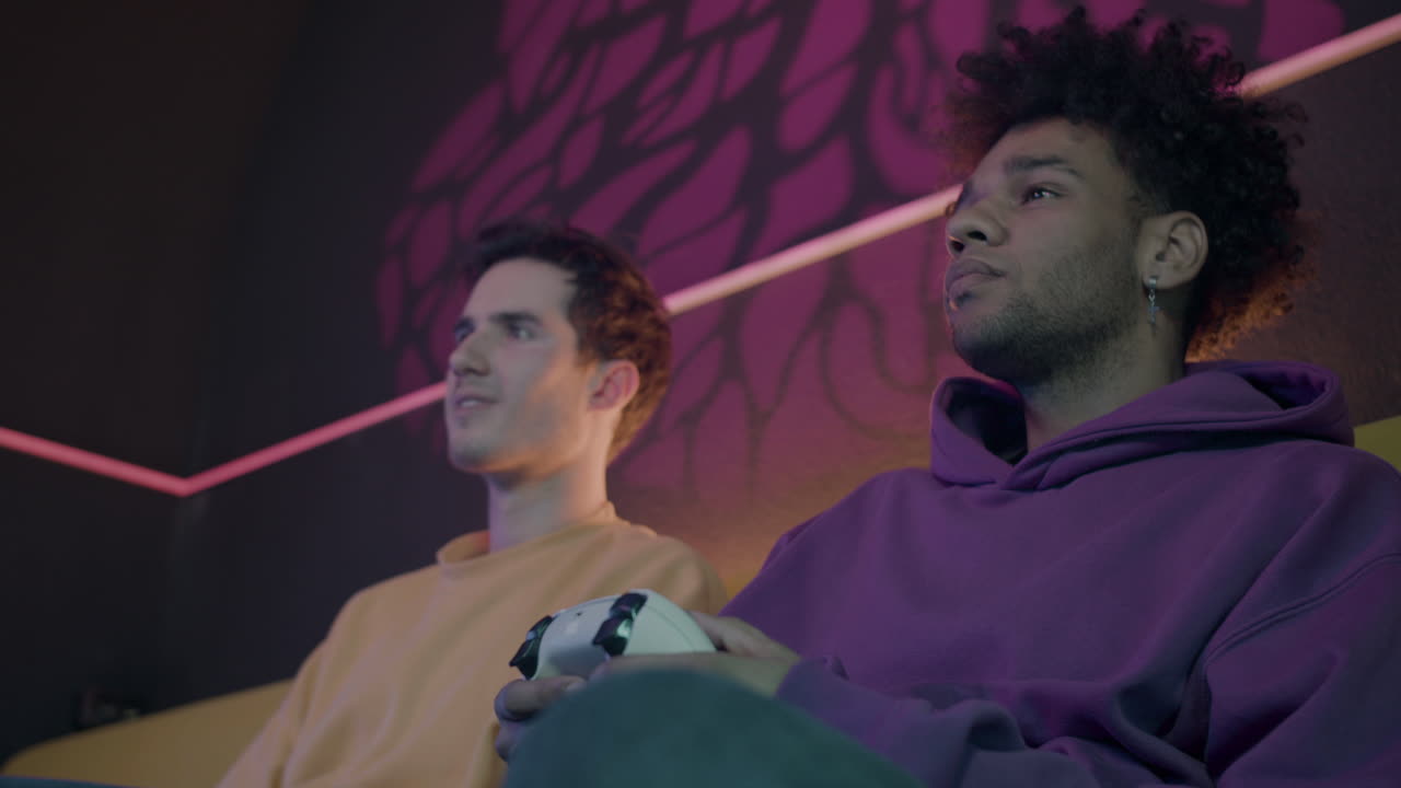 Free stock video - Bottom view of two excited friends playing video ...