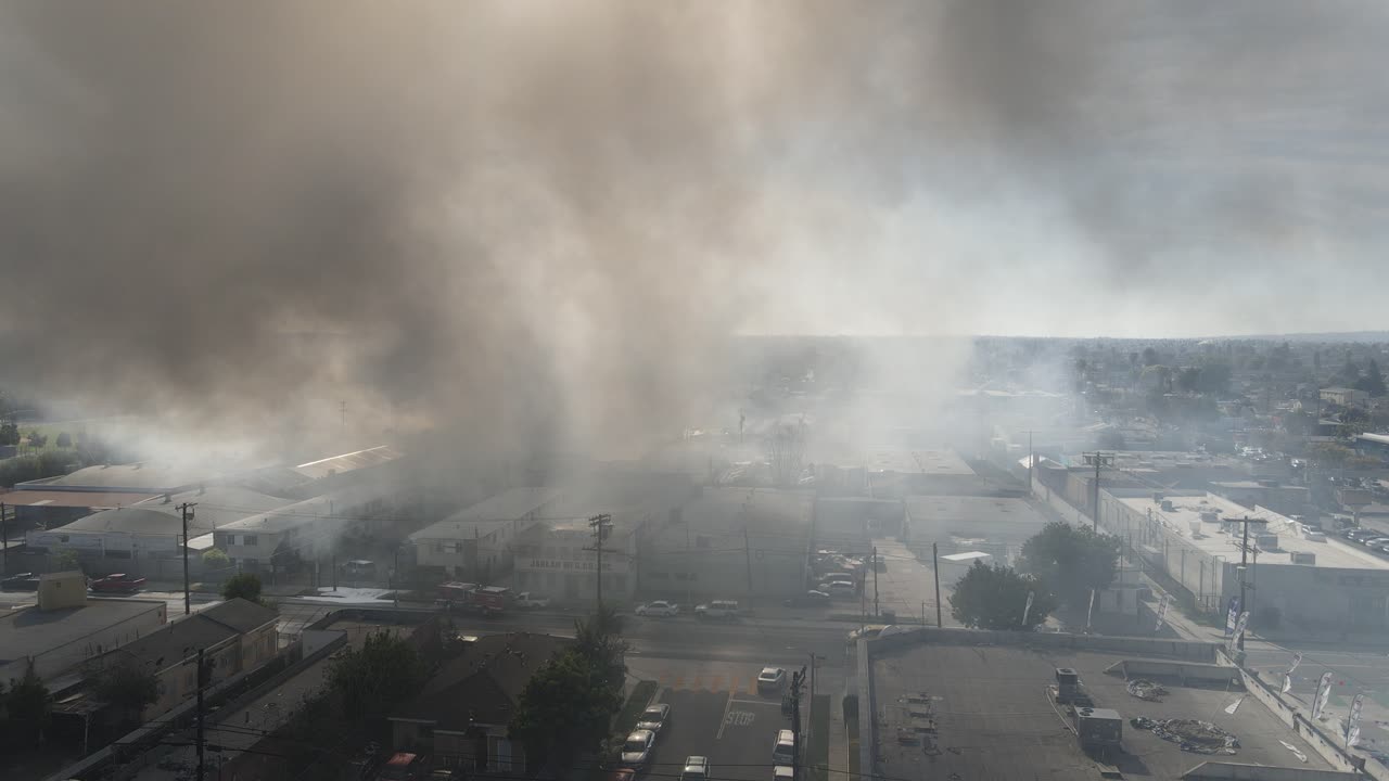 Premium stock video - Large structure fire fills streets with smoke