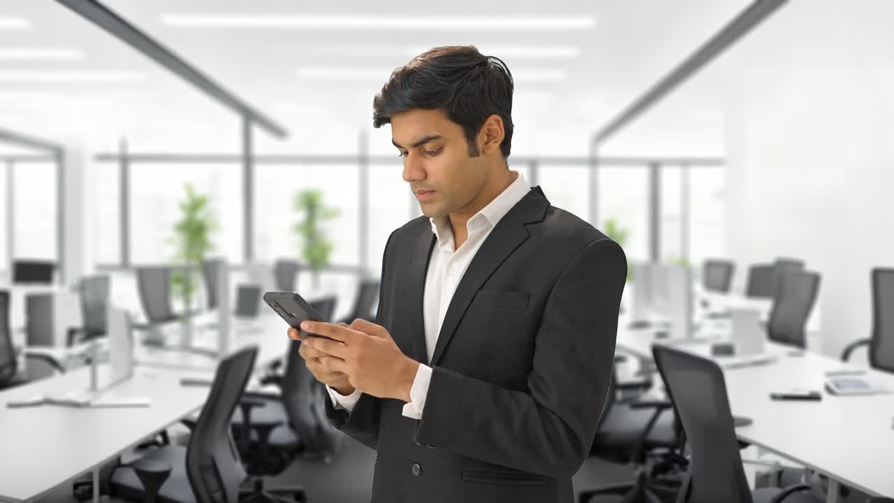 Premium stock video - Angry indian businessman texting someone