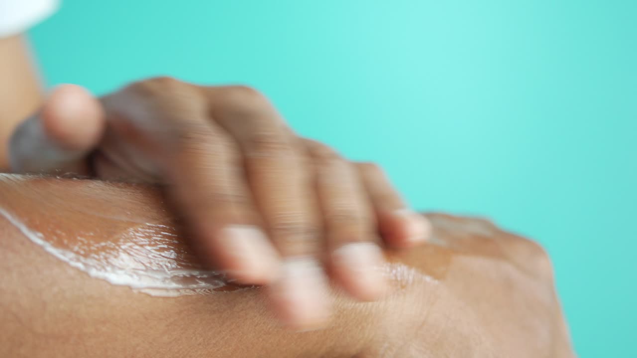 Applying lotion to the arm | Premium Stock Video Footage