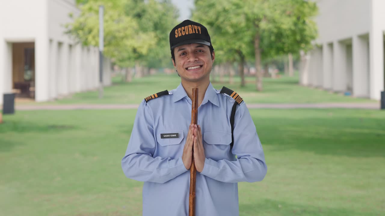 Premium stock video - Happy indian security guard doing namaste
