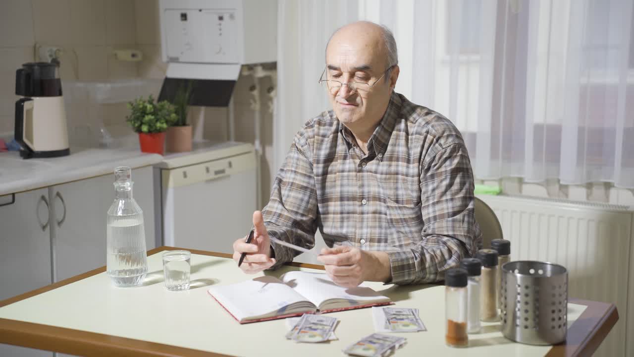 Premium stock video - Poor retired man struggling with household budget.
