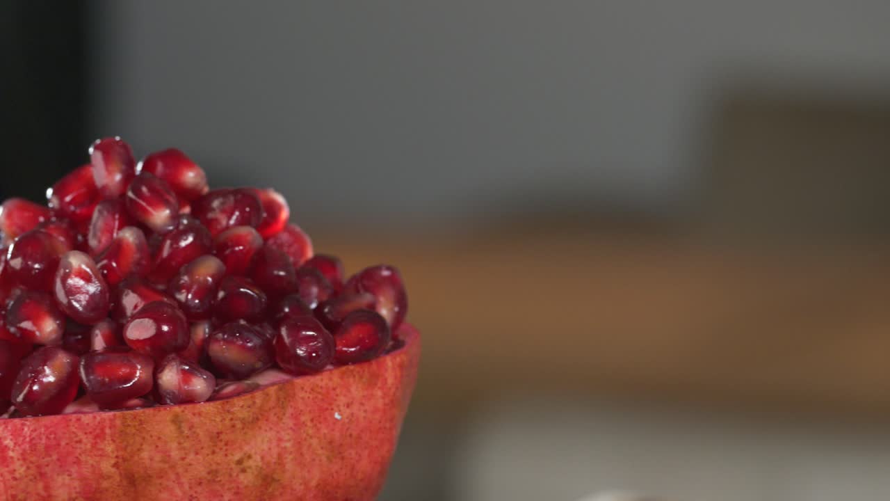 Premium stock video - Pomegranate seeds in a pomegranate shell are ...