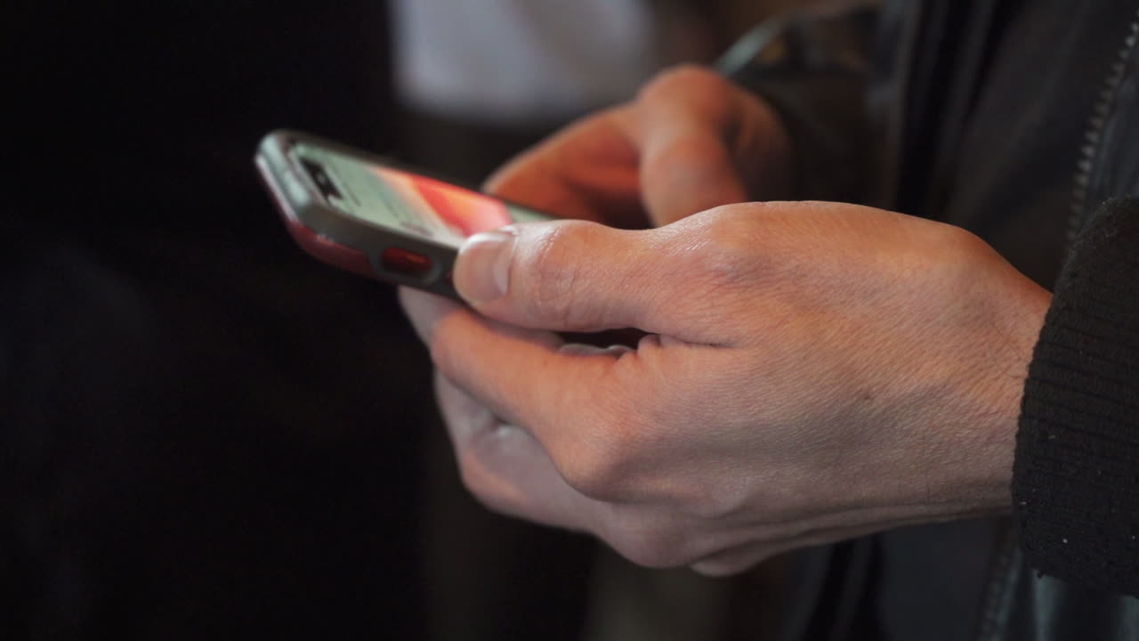 Premium stock video - Slow motion of man working a smartphone