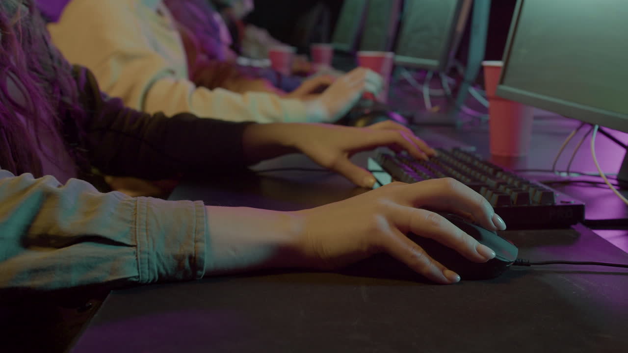Close up of a female gamer's hand on a computer mouse playing virtual ...