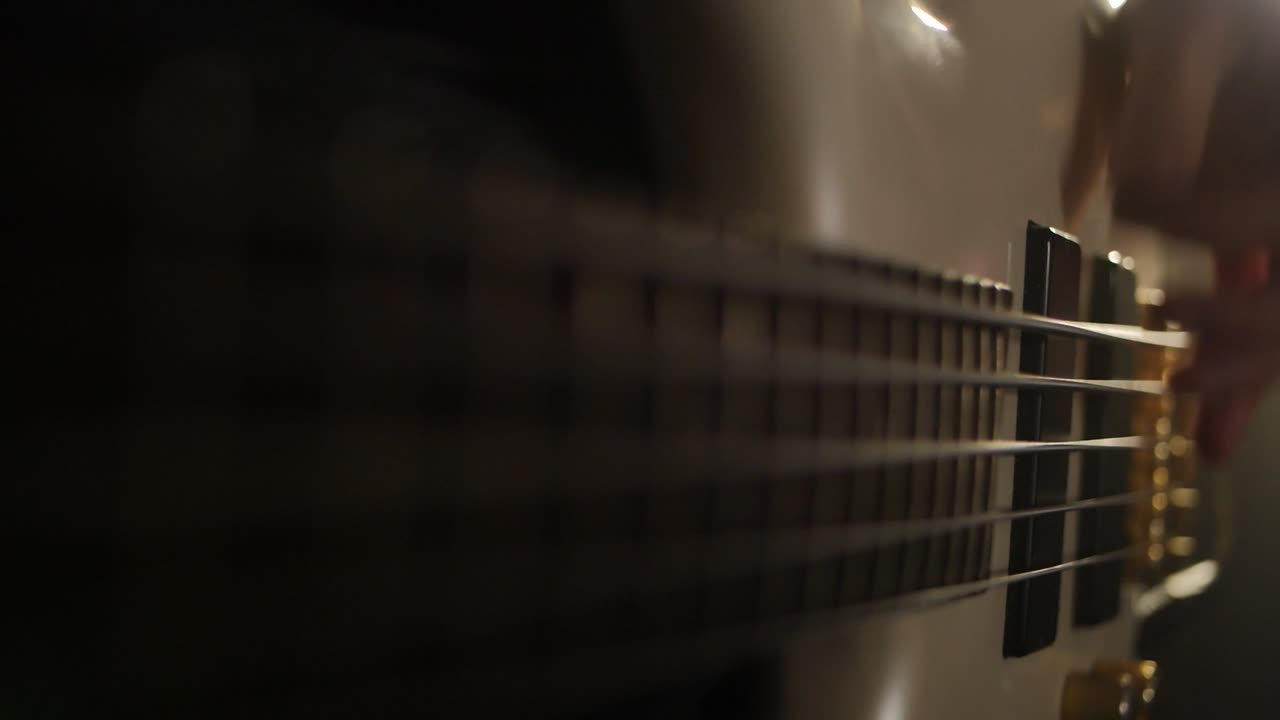 Slowmotion shot of bass string vibration. | Premium Stock Video Footage