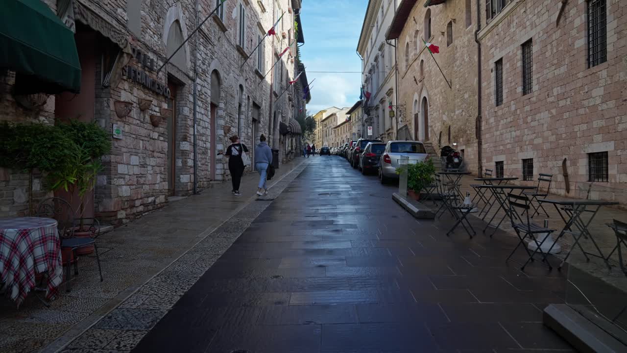 Shops with people walking on the scenic alleys in the medieval town of ...