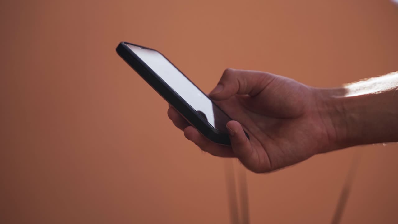 Premium stock video - Close up of a man's hand texting on the mobile phone