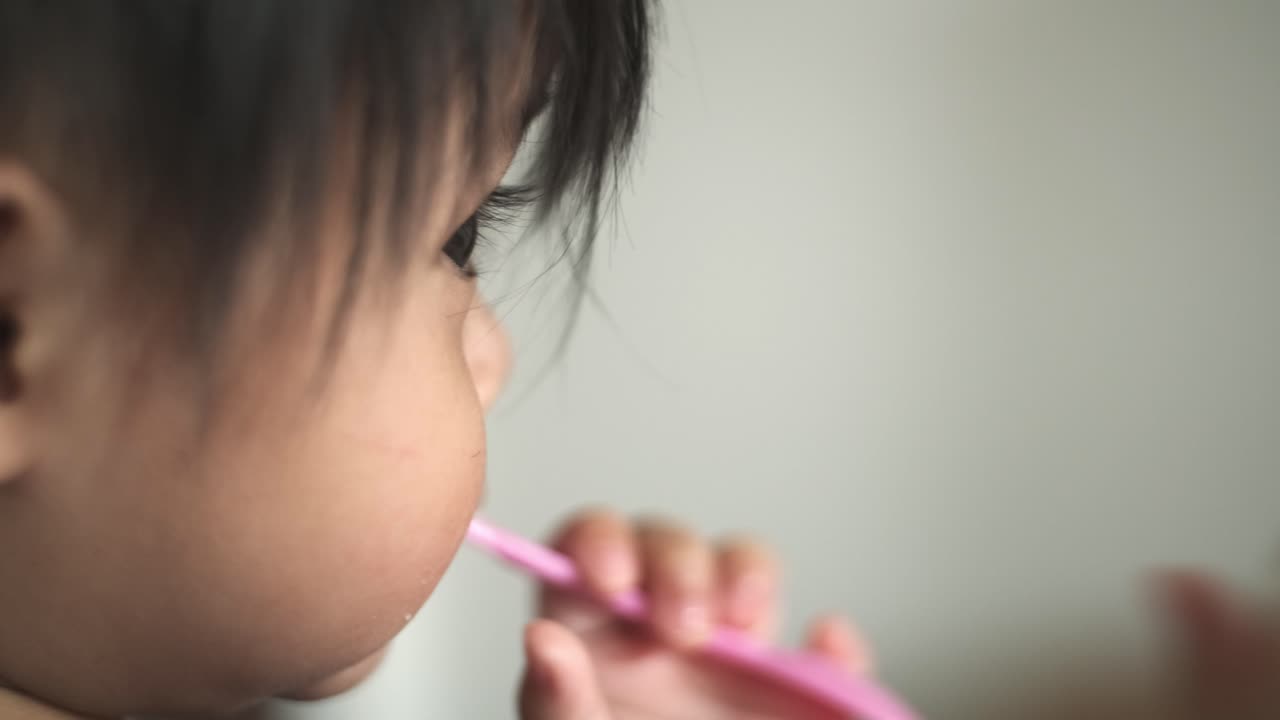 Premium stock video - Malaysian toddler chewing on food, side view ...