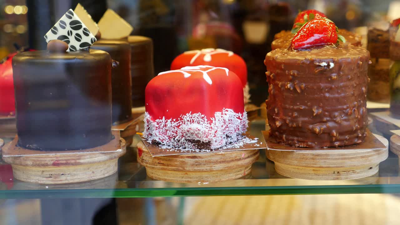 Premium stock video - Assortment of delicious cakes in a bakery showcase